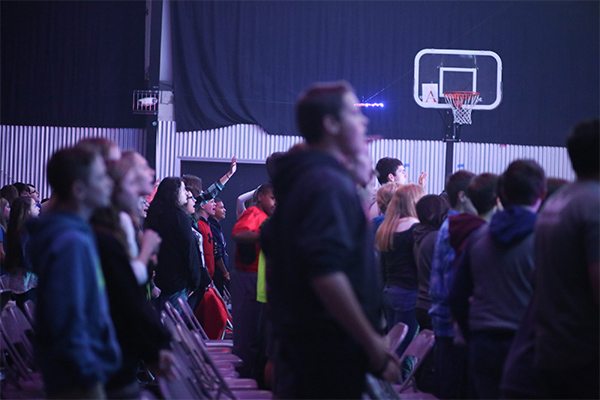 Youth at a worship service in a gymnasium - The Gospel Coalition | Canada